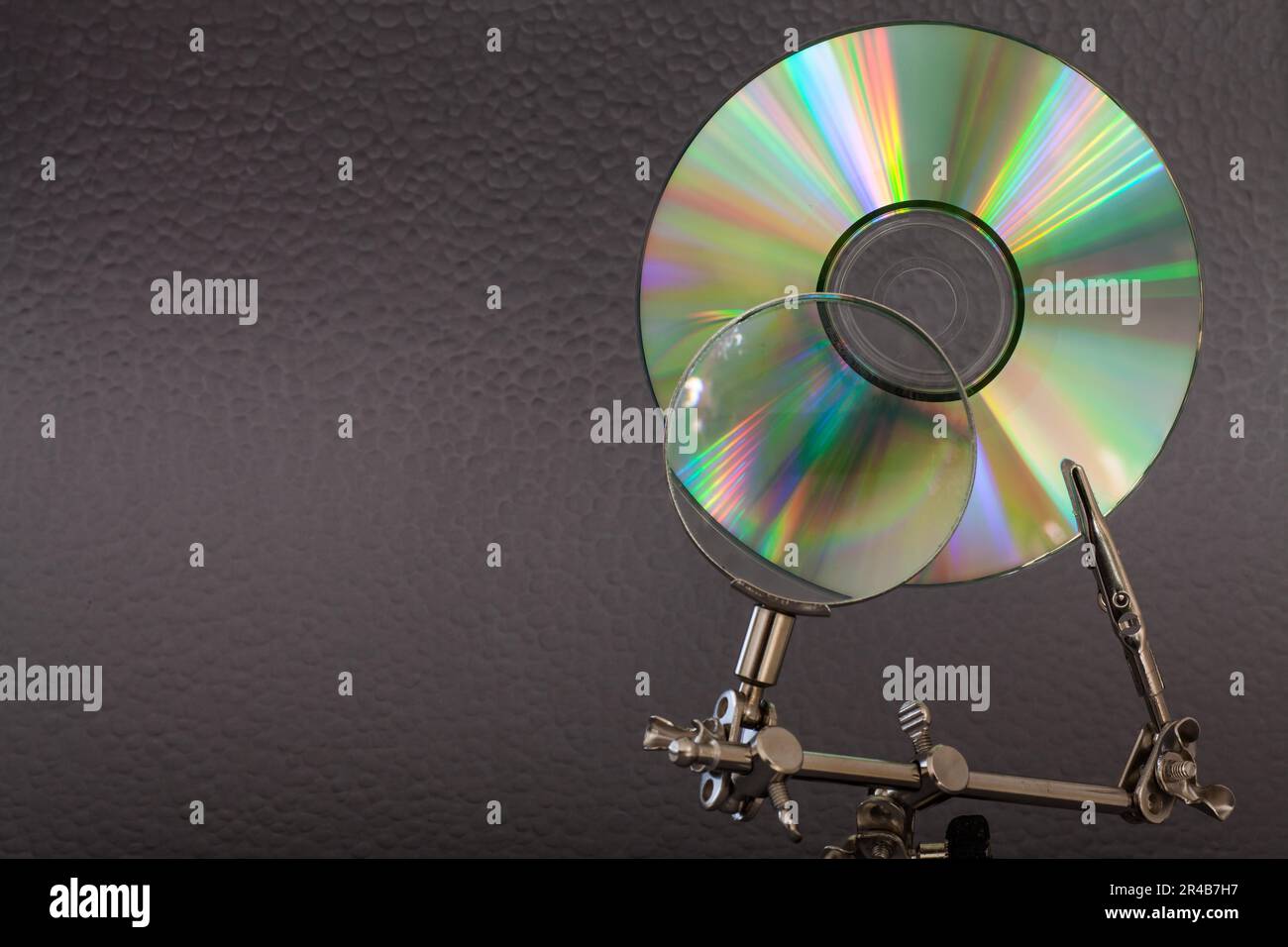 Concept for data analysis, CD and lens on a vivid colors background ...
