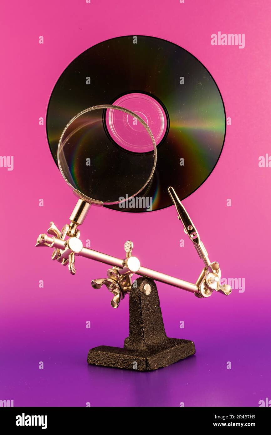 Concept for data analysis, CD and lens on a vivid colors background ...