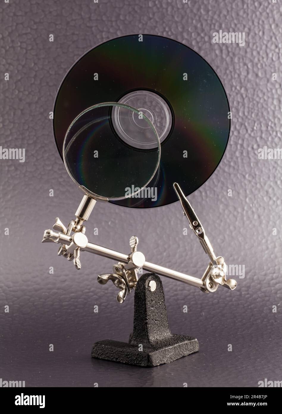 Concept for data analysis, CD and lens on a vivid colors background ...