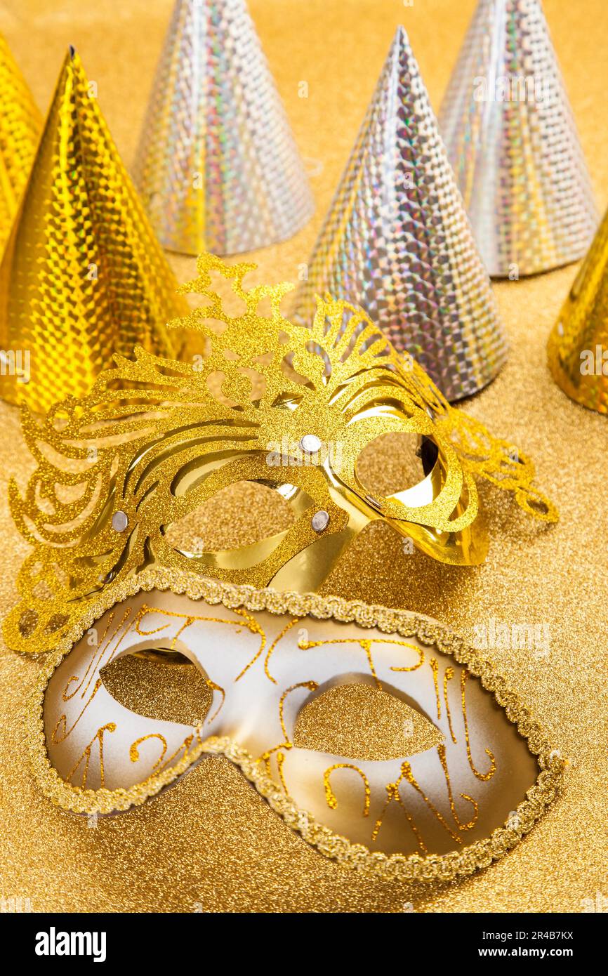 Party motive with carnival mask and party hat in golden tone Stock ...