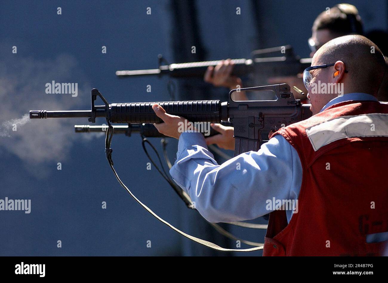 US Navy Airman fires an M-16 rifle during small arms qualifications ...