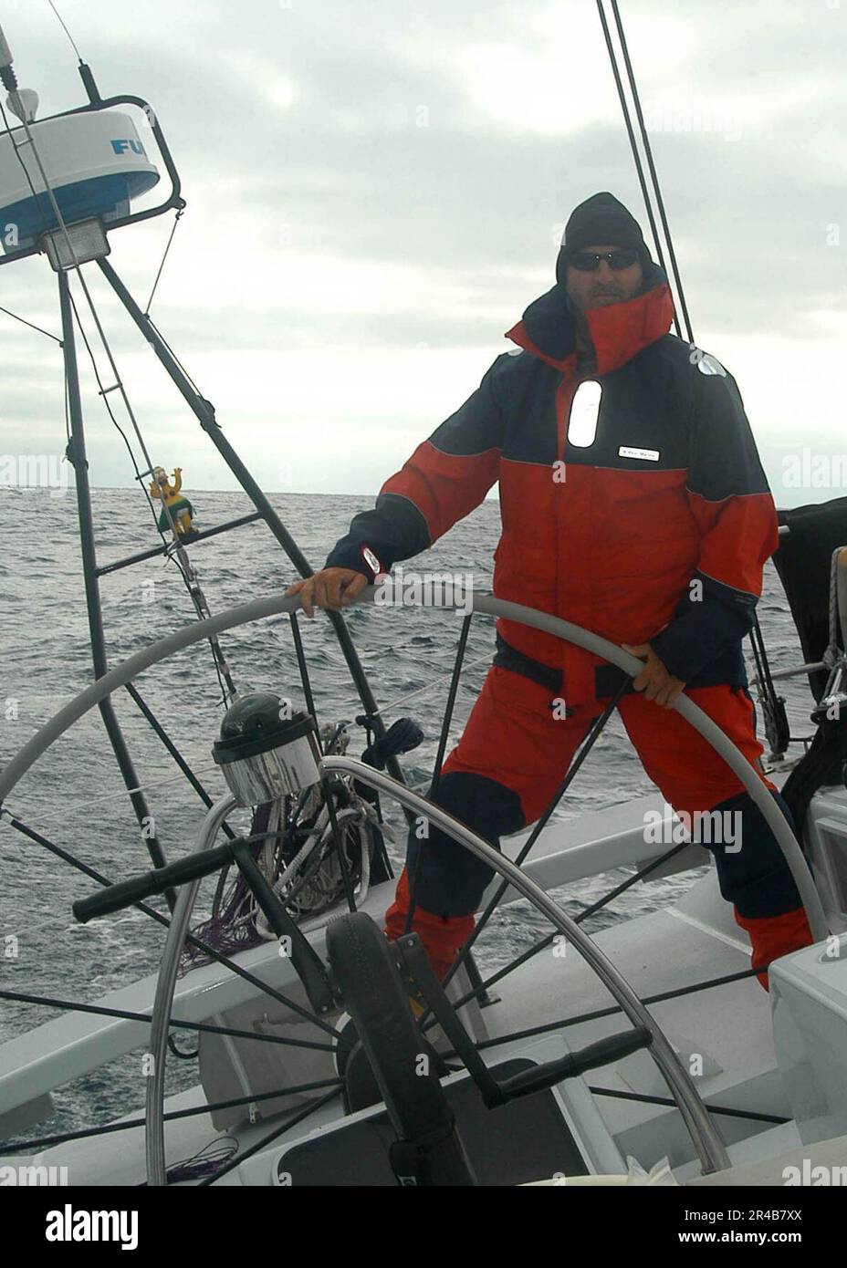 US Navy Hull Technician 1st Class mans the helm while on watch aboard ...