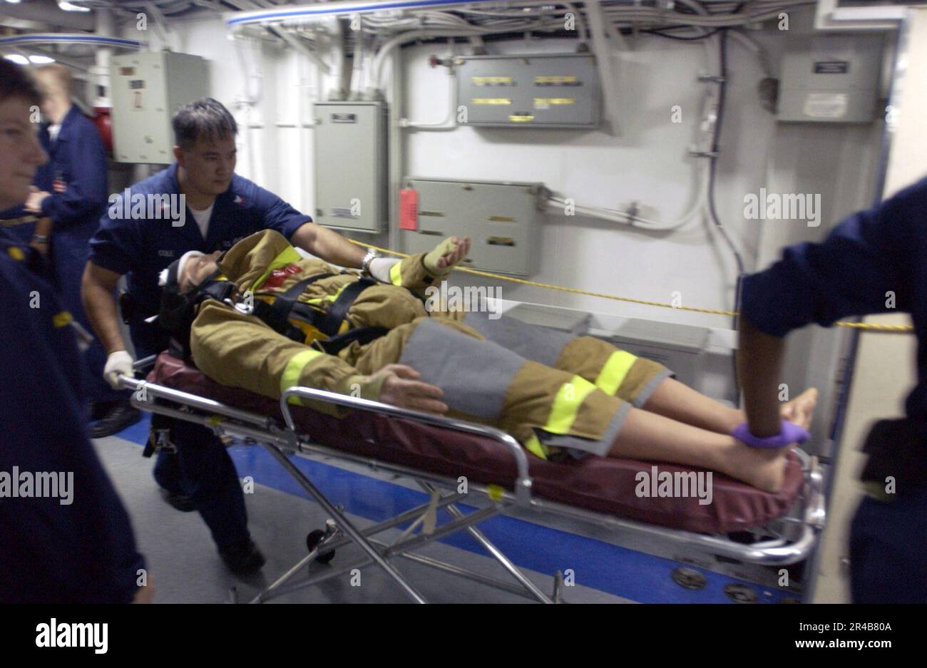 US Navy Medical personnel simulate an evacuation of a patient during ...