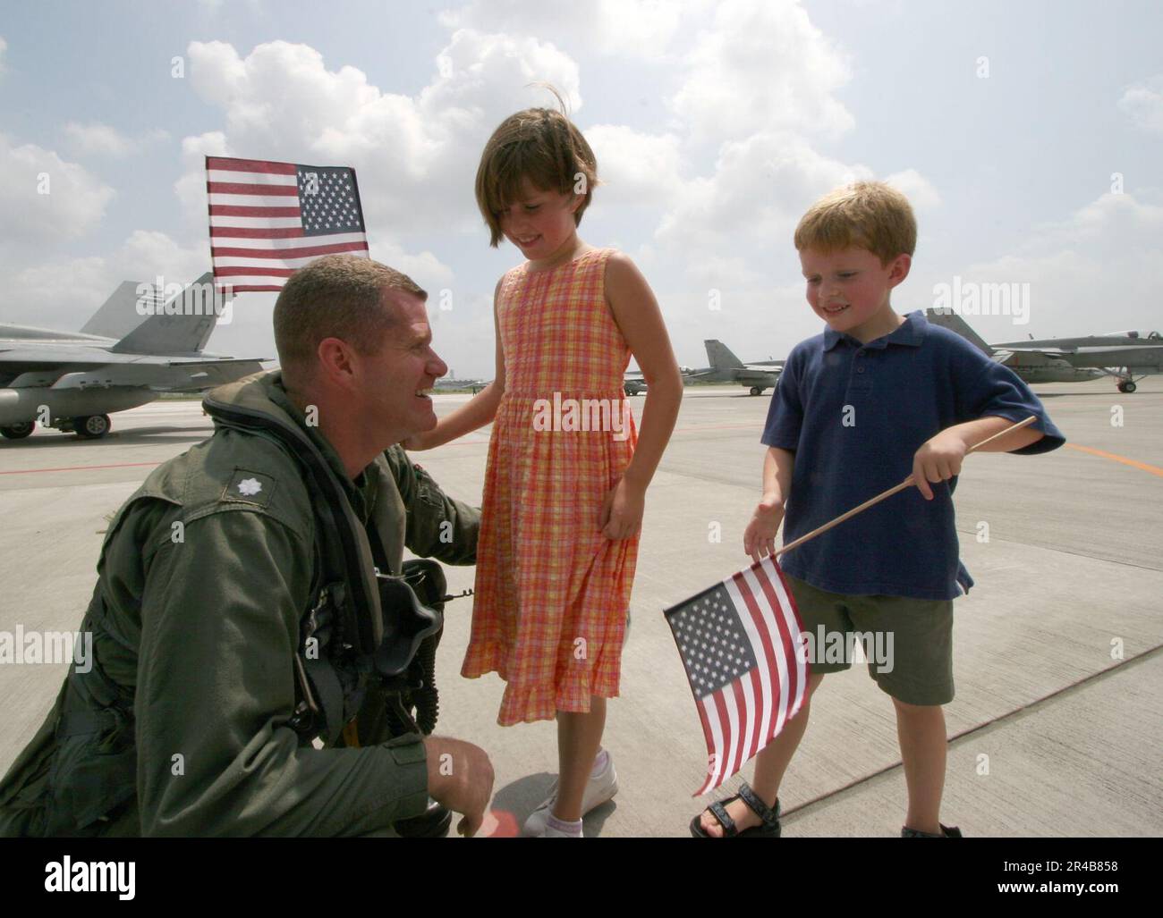 US Navy A Naval Aviator embraces his family members during the Carrier ...