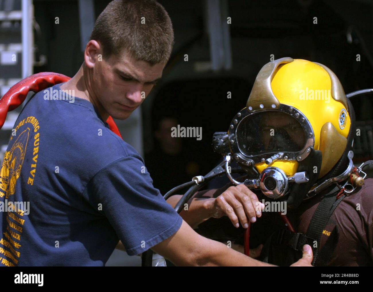 US Navy Hull Technician 3rd Class left, assists Philippine Navy diver ...