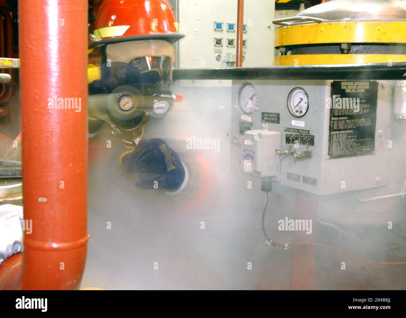 US Navy A nozzle man combats a simulated Class Alpha fire during a fire ...