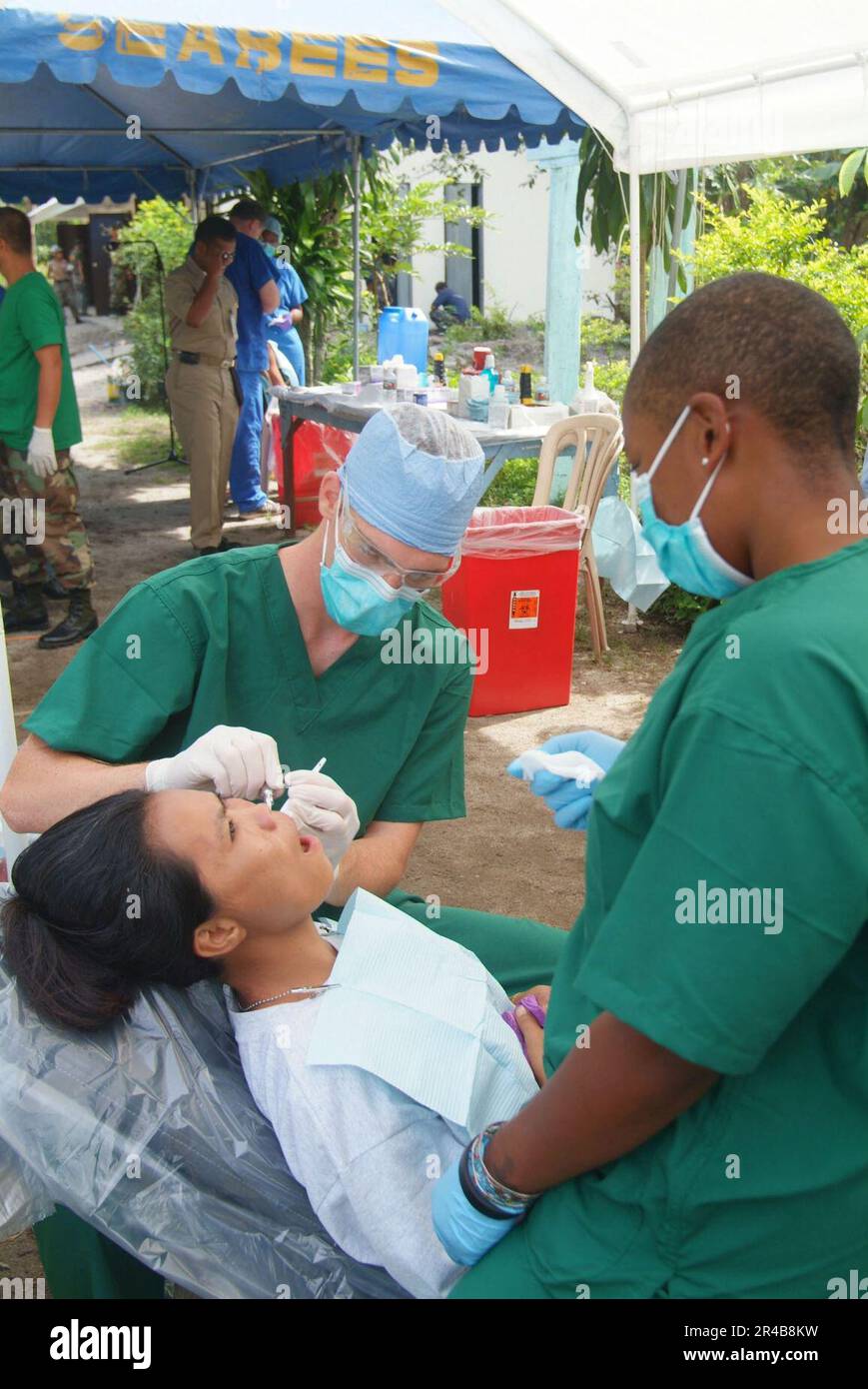 US Navy U.S. Navy dentist, Lt. and Dental Technician 3rd Class treat a ...