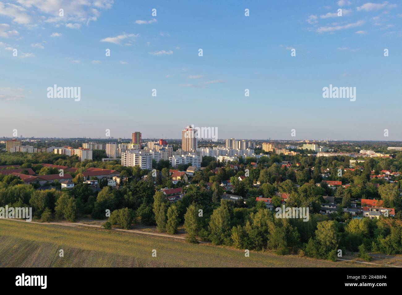 An aerial view of lush green trees and city buildings in Marienfelde ...