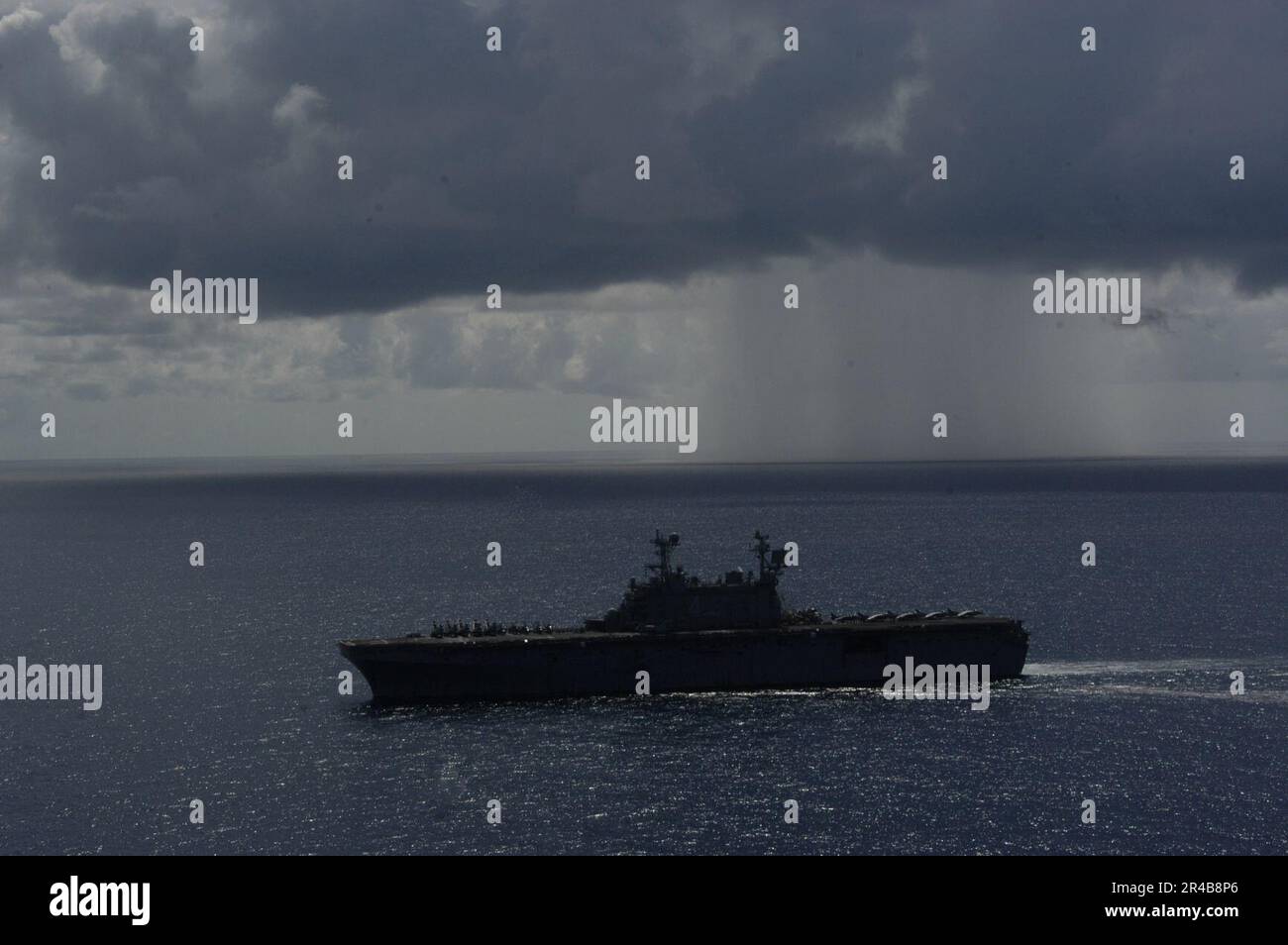 US Navy Rain showers approach the amphibious assault ship USS Nassau ...