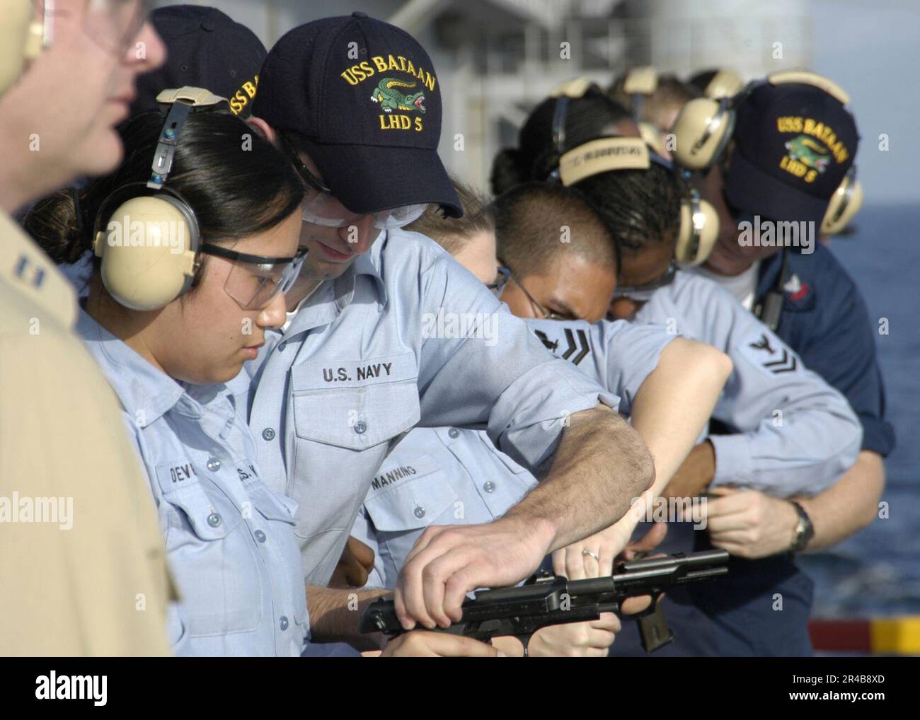 US Navy Sailors take part in a 9mm live fire training exercise on the ...