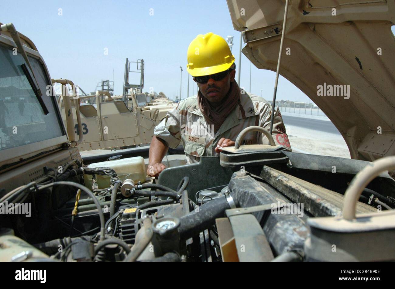 US Navy Boatswain's Mate 2nd Class inspects a High-Mobility ...