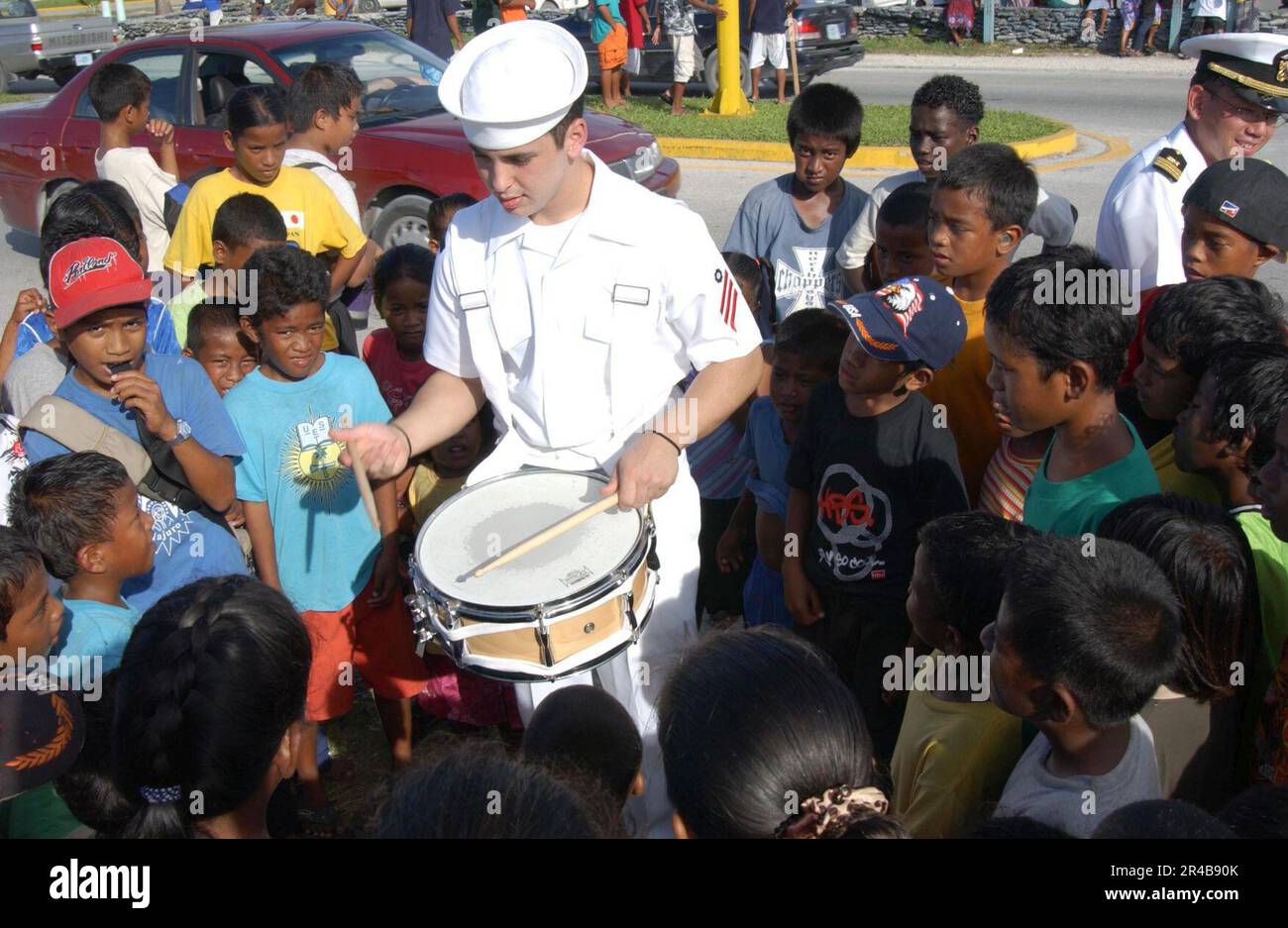 US Navy Engineman Fireman plays the drums for local children in Majuro ...