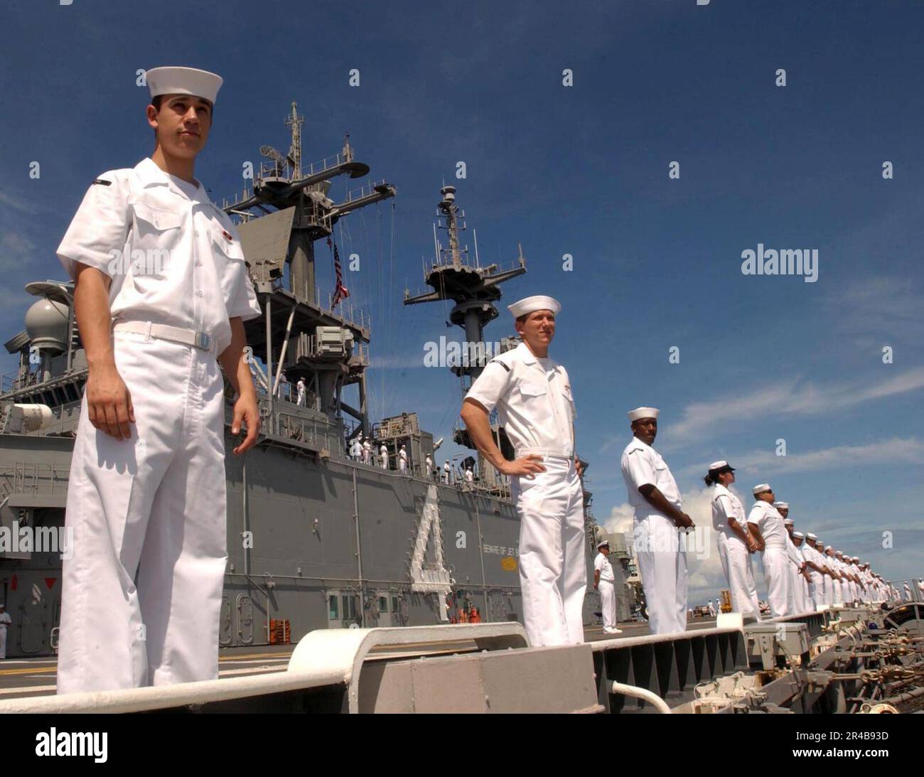 US Navy Sailors man the rails as the amphibious assault ship USS Boxer ...