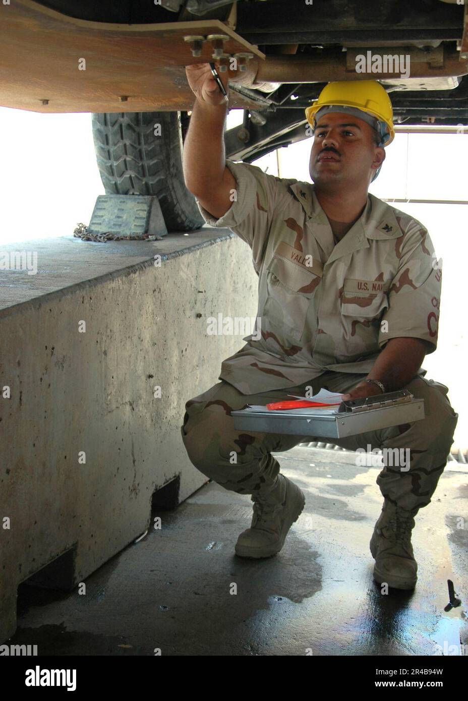 US Navy Yeoman 2nd Class inspects a High-Mobility Multipurpose Wheeled ...