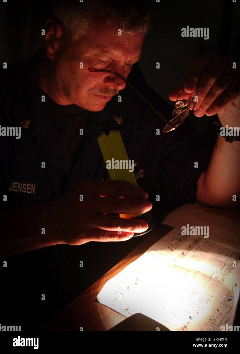 US Navy Coast Guard Chief Petty Officer looks over the barracks room ...