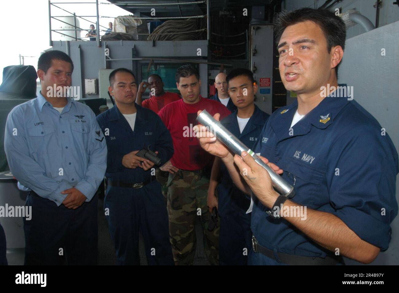 US Navy Gunner's Mate 1st Class discusses proper procedures for loading ...