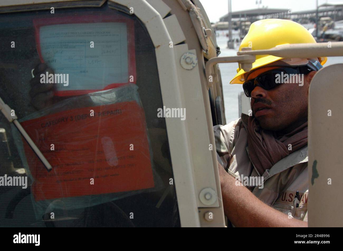 US Navy Boatswain's Mate 2nd Class attaches a U. S. Customs form Stock ...