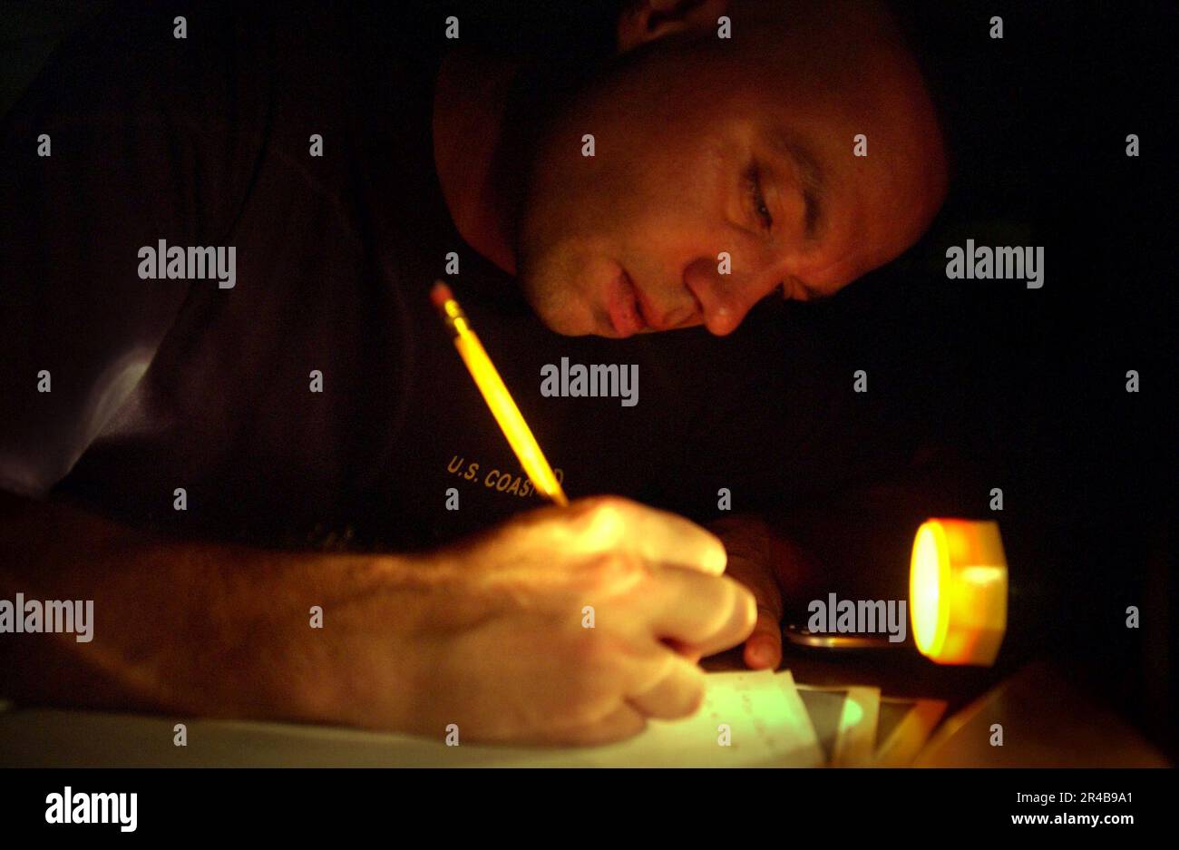 US Navy Coast Guard Petty Officer 2nd Class writes down the locations ...