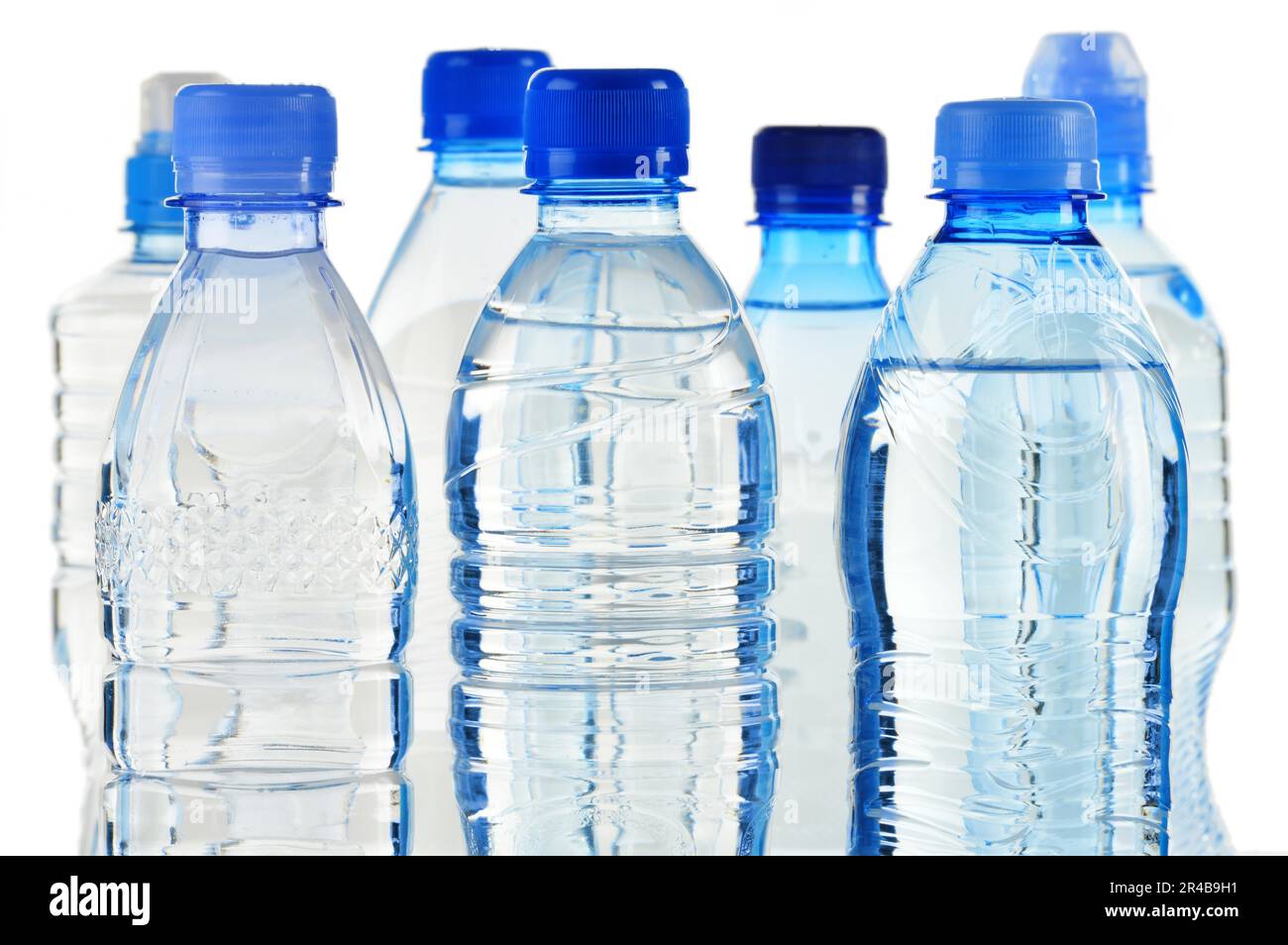 Composition with polycarbonate plastic bottles of mineral water isolated on white background ...