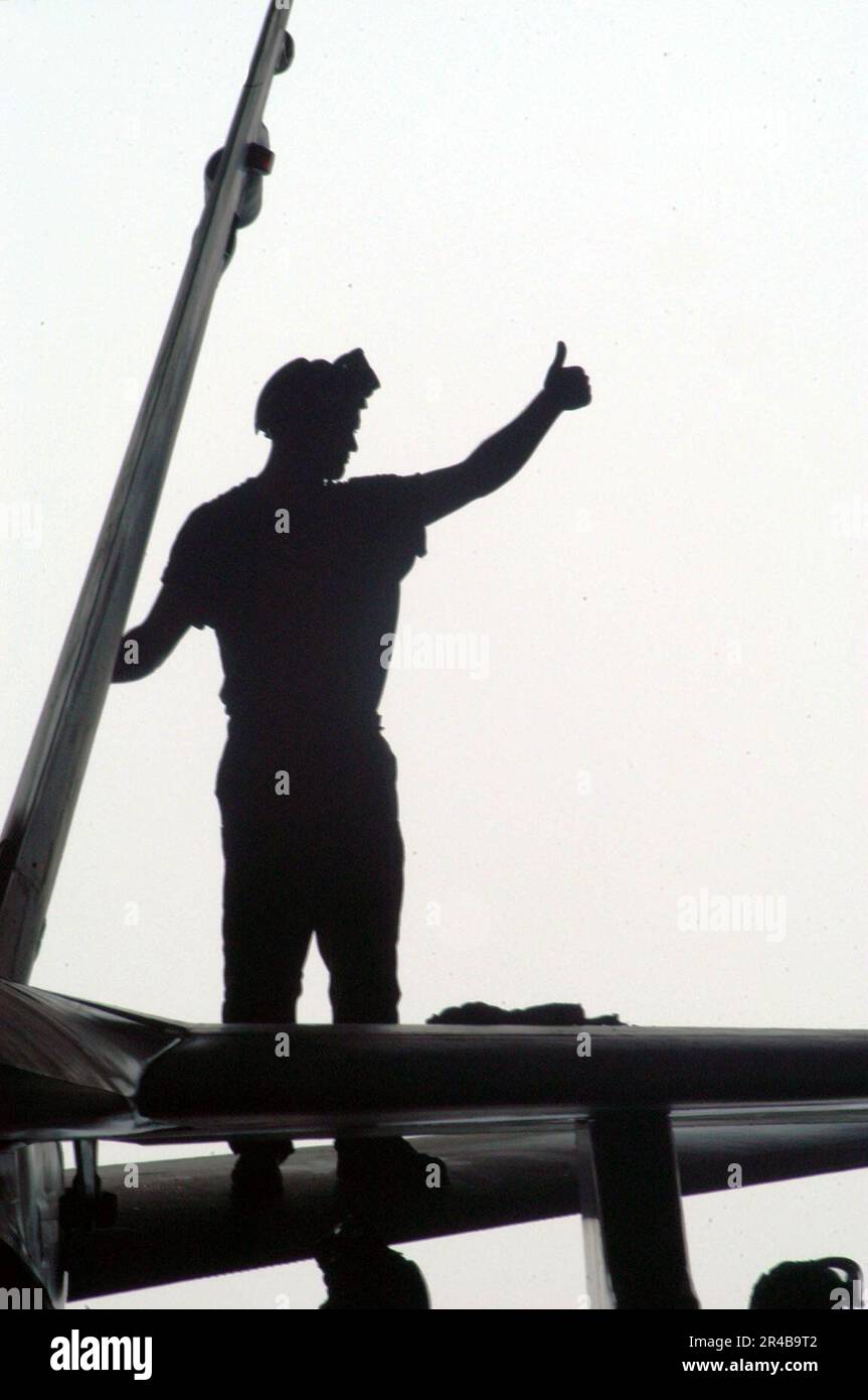 US Navy An Airman gives the thumbs up signal after a successful test of ...