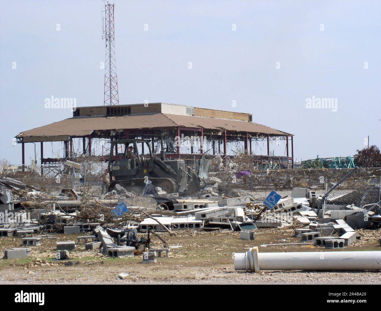 US Navy A U.S. Navy Seabee uses a bulldozer to remove debris from ...