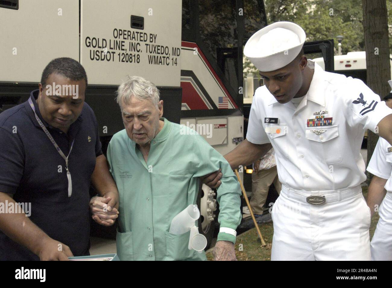 US Navy Yeoman 2nd Class and a civilian volunteer guide a retired ...