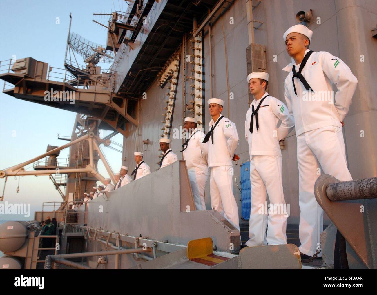 US Navy Sailors man the rails aboard the Nimitz class aircraft carrier ...