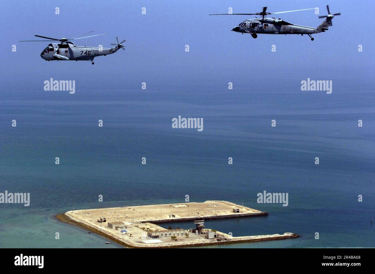 US Navy A UH-3H Sea King helicopter and a MH-60S Seahawk helicopter fly ...