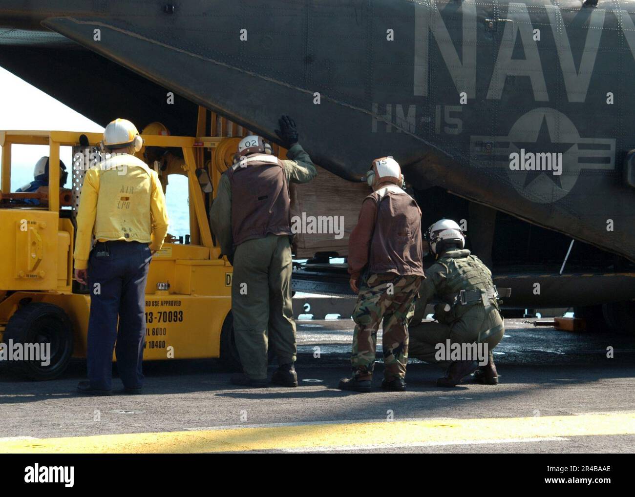 US Navy Sailors load a MH-53E Sea Dragon helicopter with water to ...
