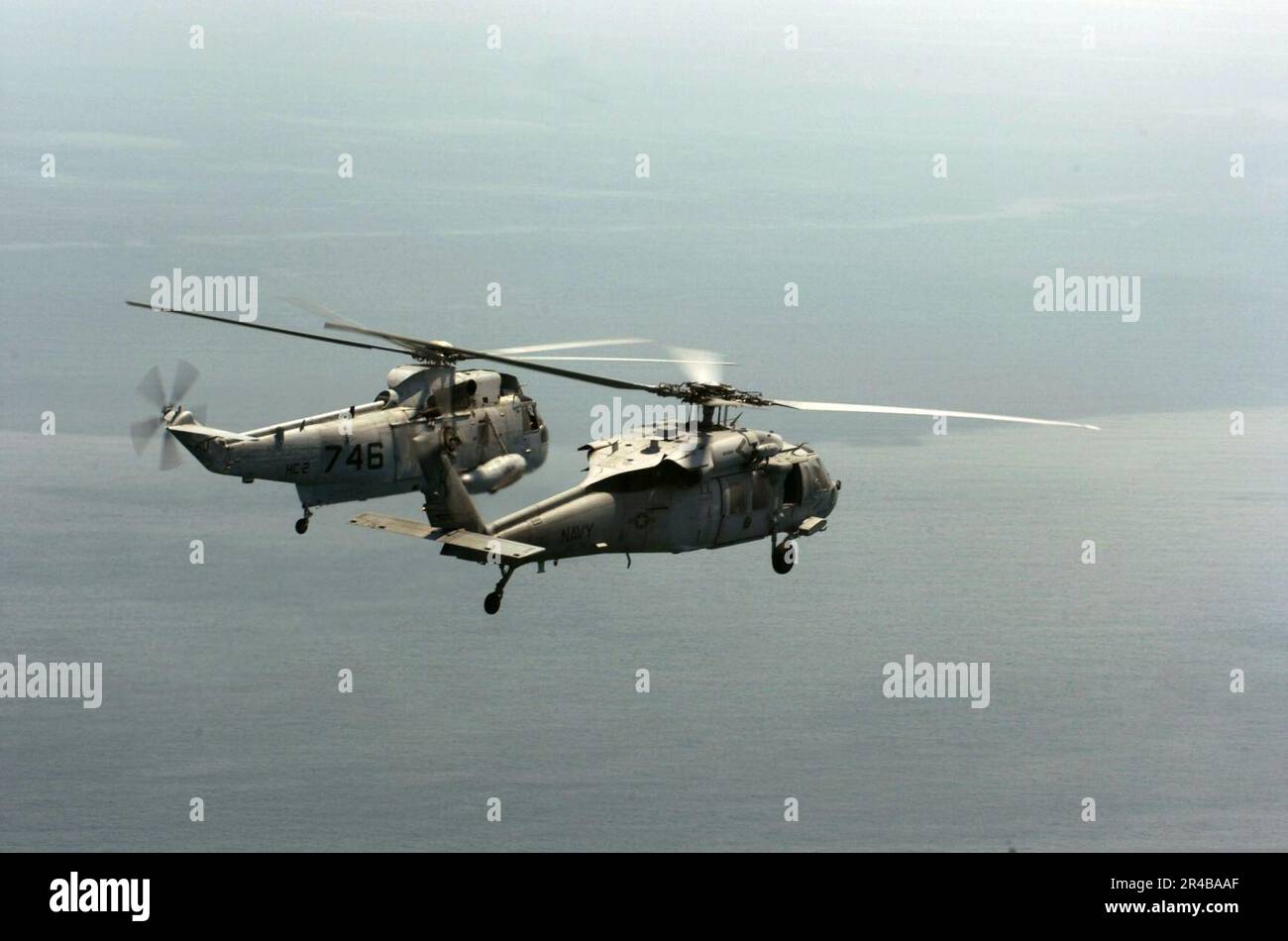 US Navy A UH-3H Sea King helicopter and a MH-60S Seahawk helicopter fly ...