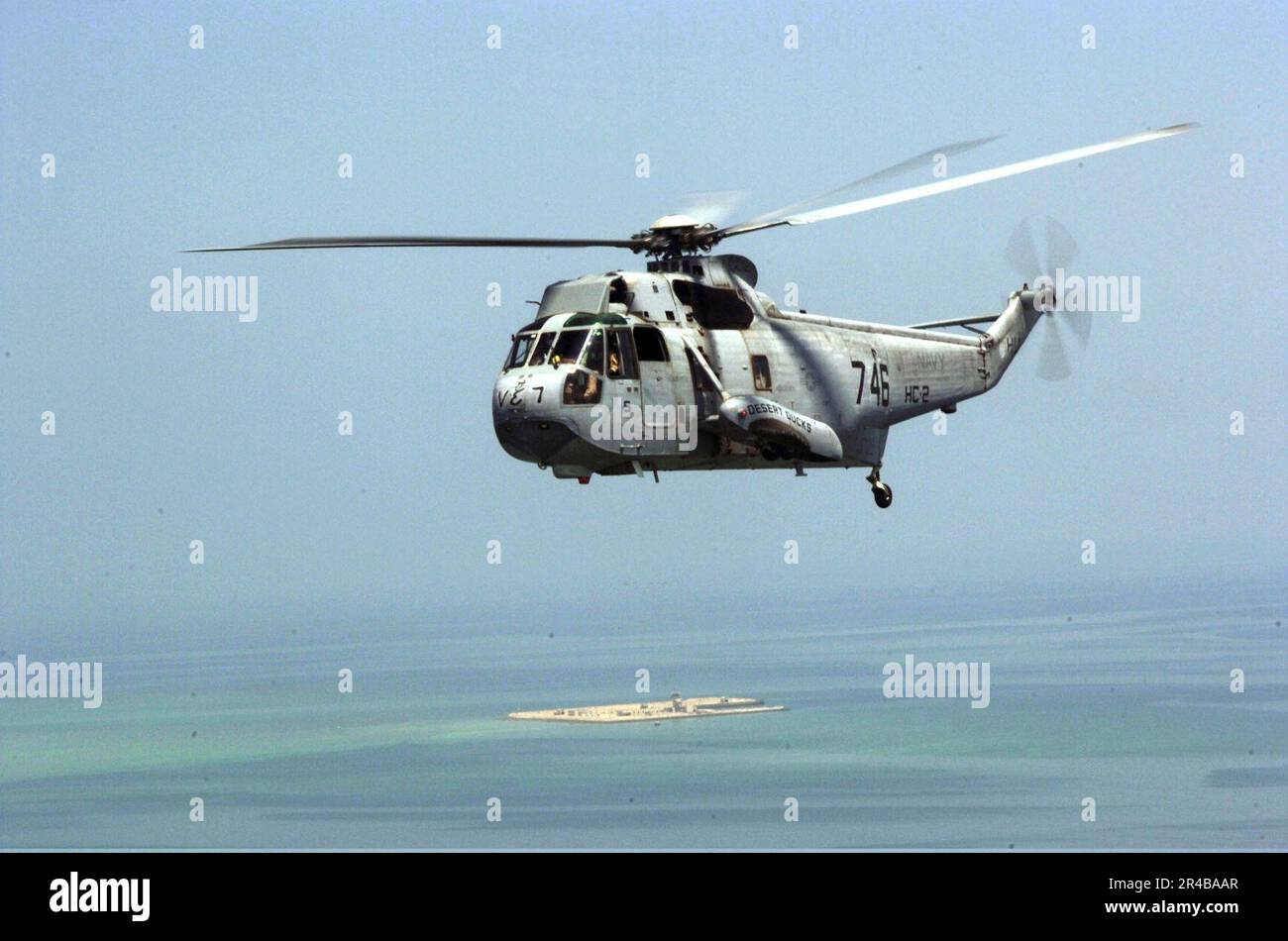 US Navy A UH-3H Sea King helicopter flies over Fast Al Jarim Island ...
