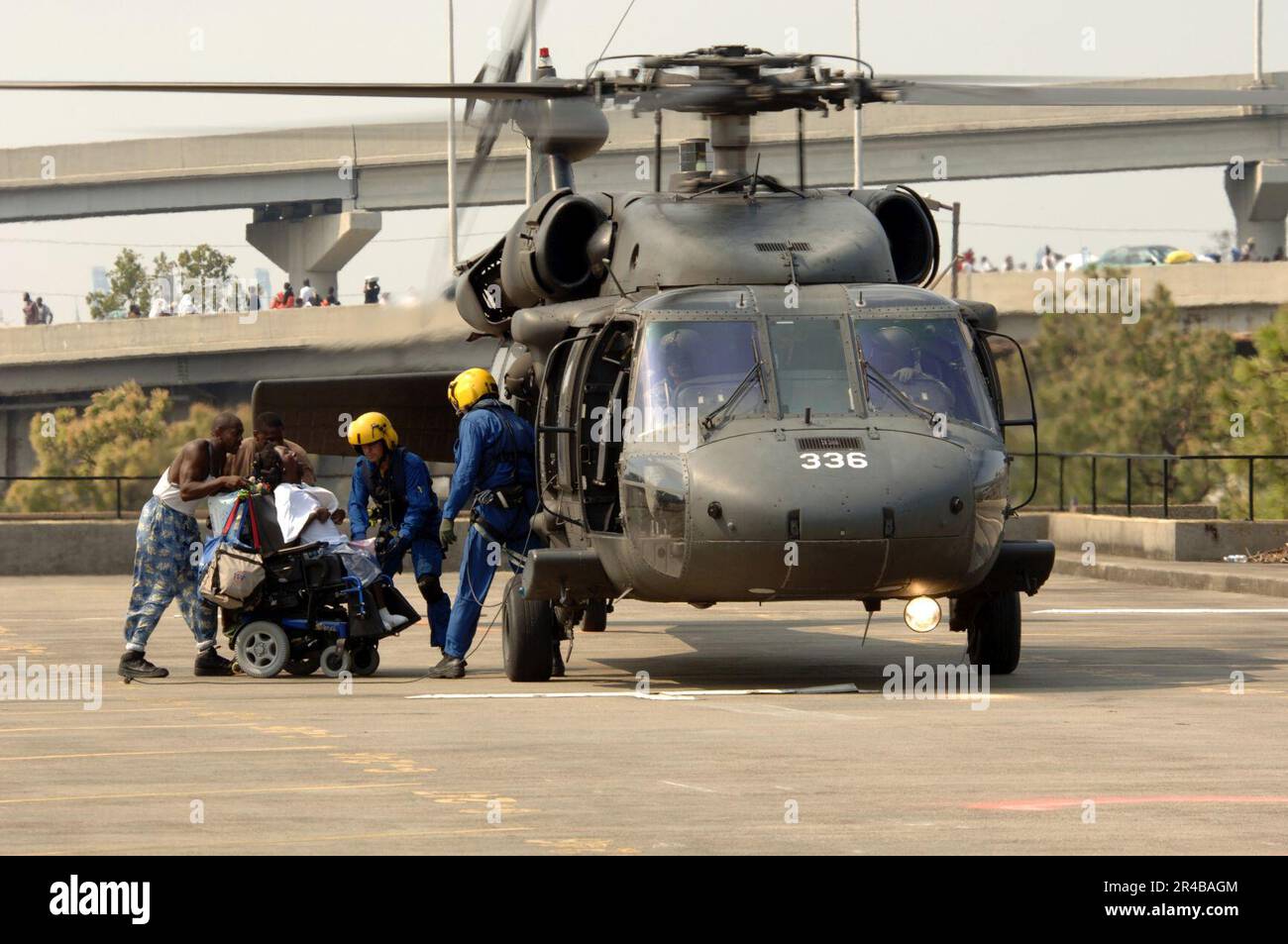 US Navy National Guard members carry a handicapped man into a waiting ...