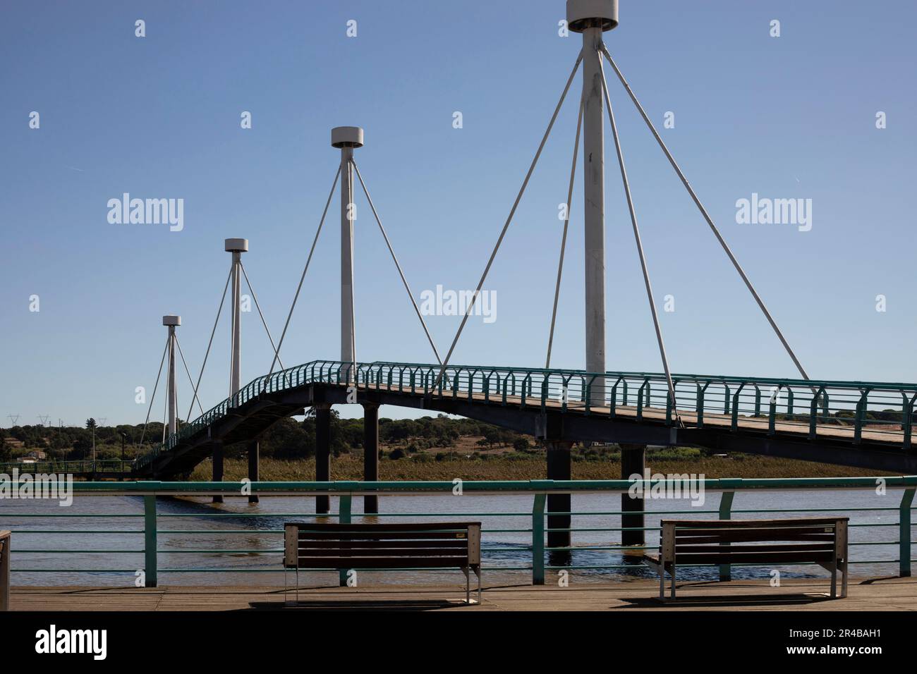 A picturesque bridge spans a body of water, with a dock visible in the ...