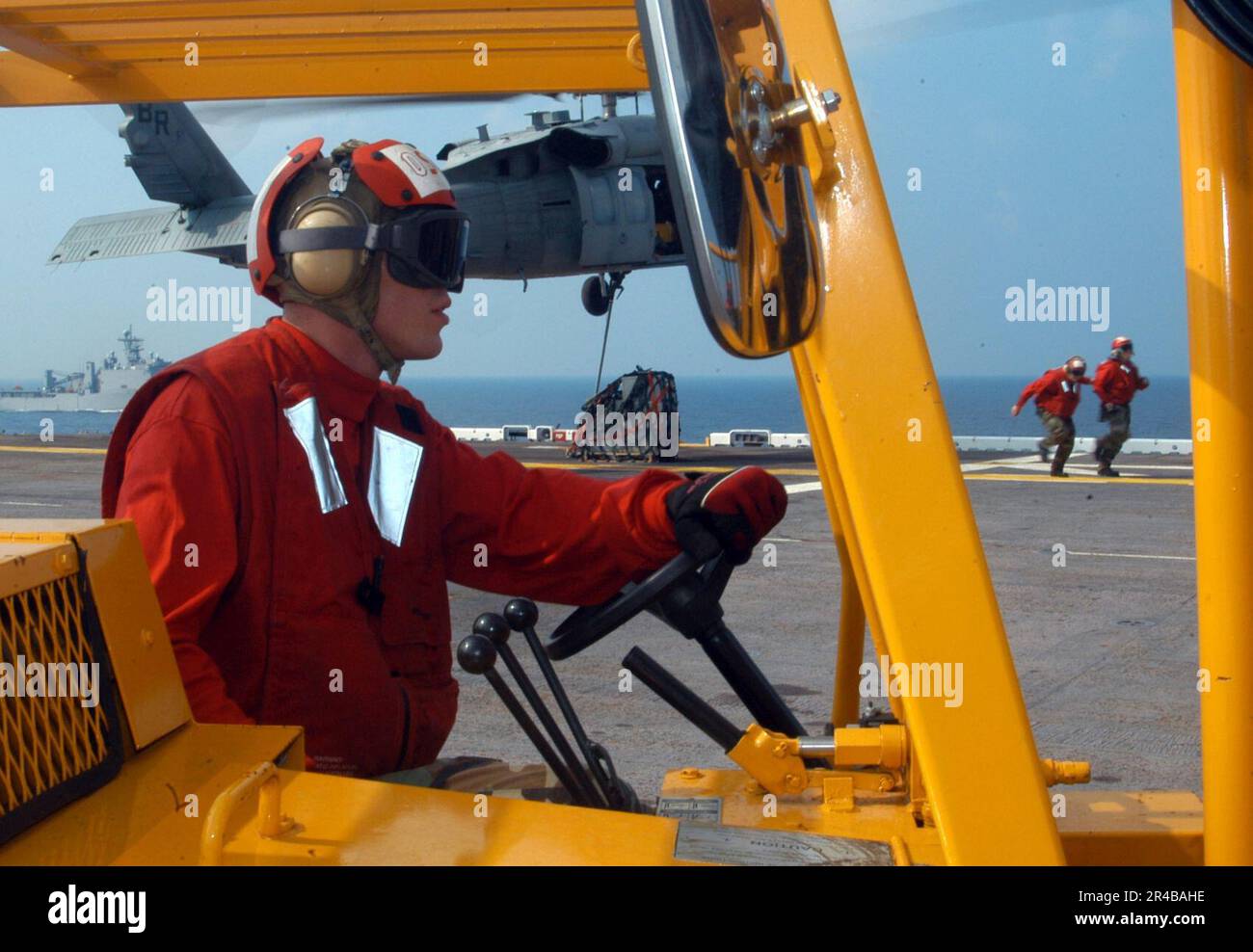 US Navy Aviation Ordnanceman 3rd Class hauls equipment on a forklift to ...