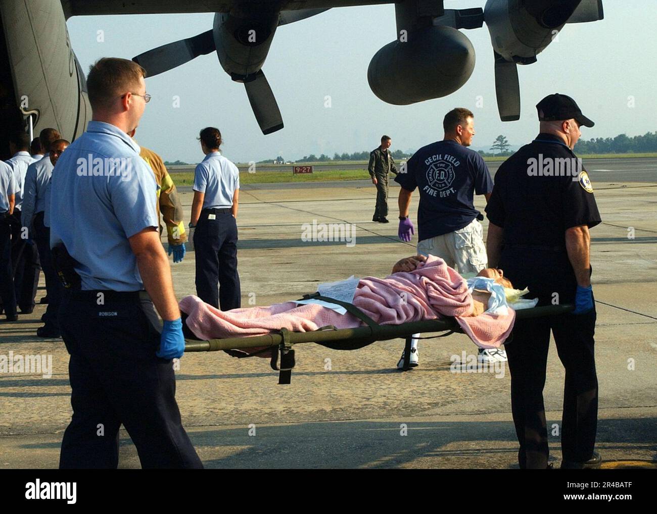 US Navy A U.S. Navy Sailor and an emergency medical technician assist ...