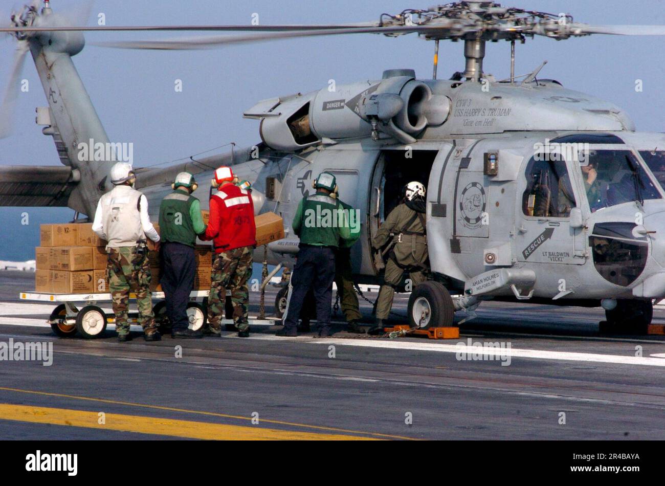 US Navy Air Department personnel load Meals Ready-to-Eat (MREs) onto an ...