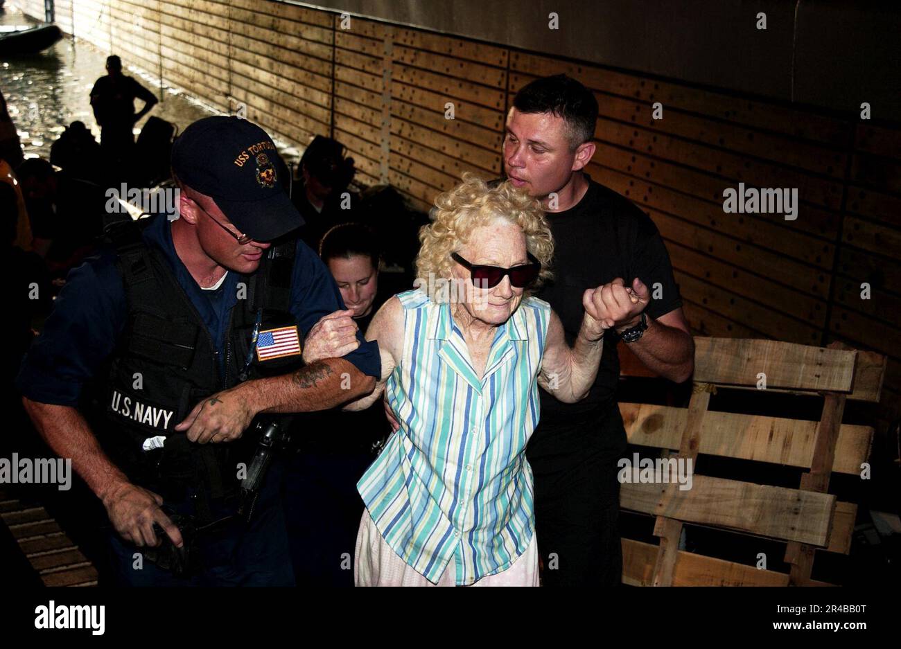 US Navy U.S. Navy Sailors help a New Orleans citizen up through the ...
