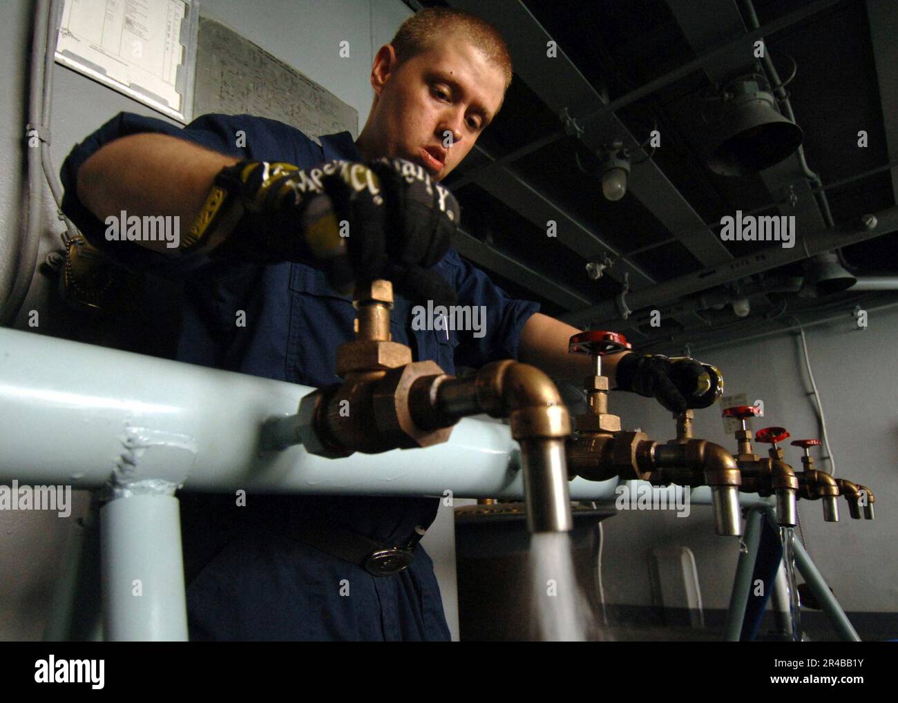 US Navy Machinist's Mate 3rd Class performs a test on a newly ...