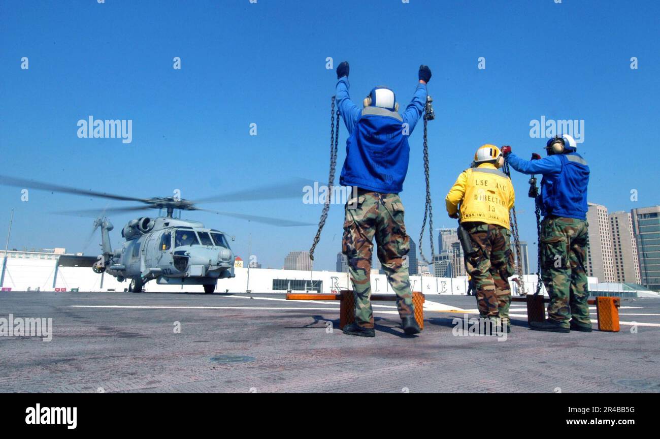 US Navy U.S. Navy Aviation Boatswains Mates signal to a SH-60B Seahawk ...