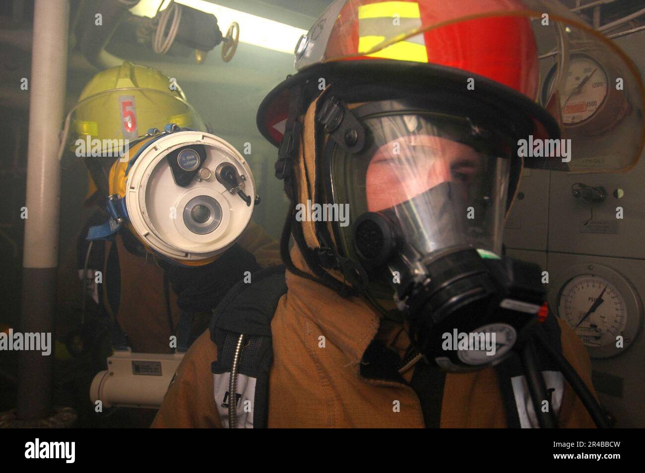 US Navy Gas Turbine System Technician 3rd Class leads his fire fighting ...