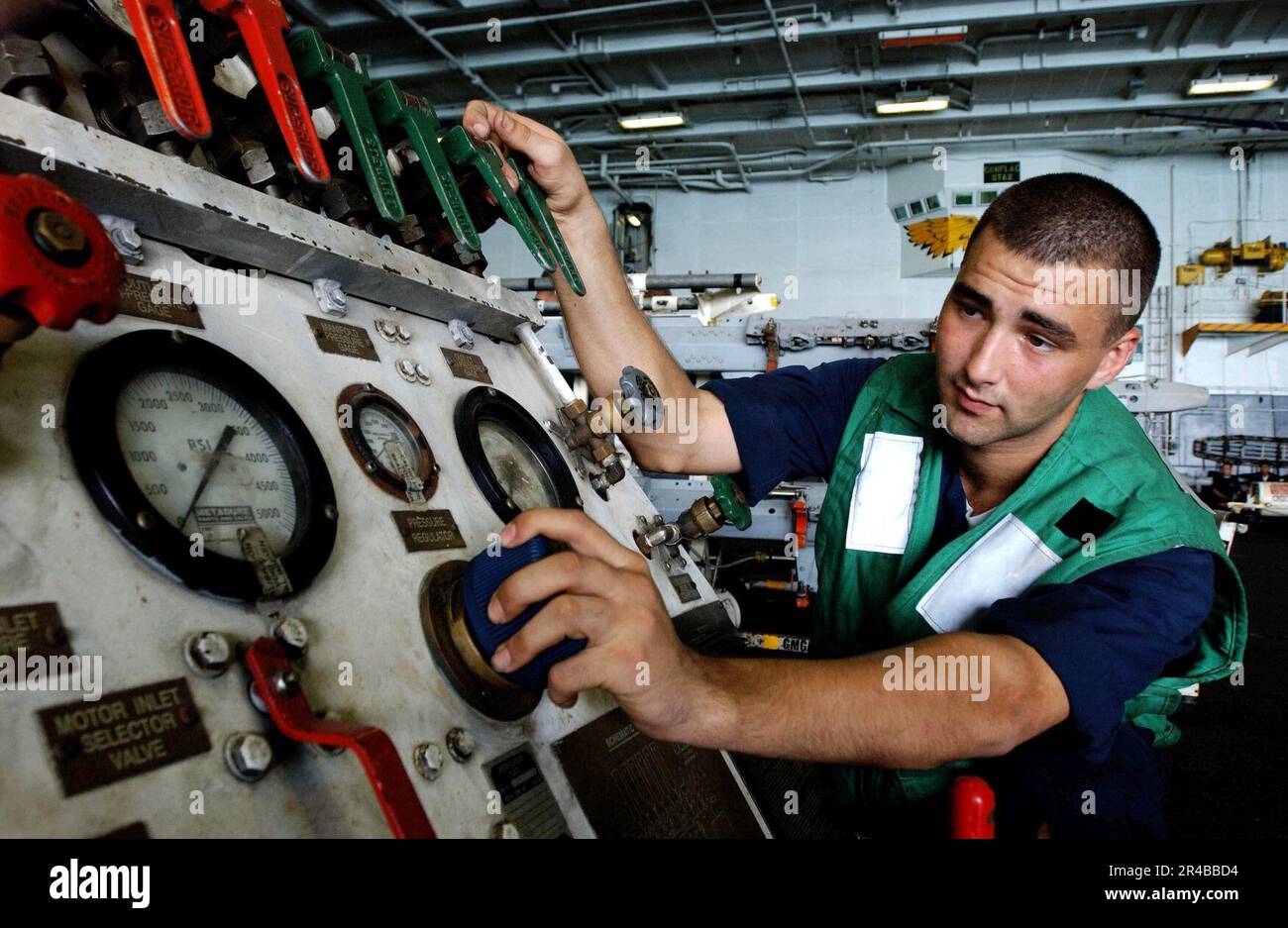 US Navy Aviation Structural Mechanic Airman pressurizes a nitrogen line ...