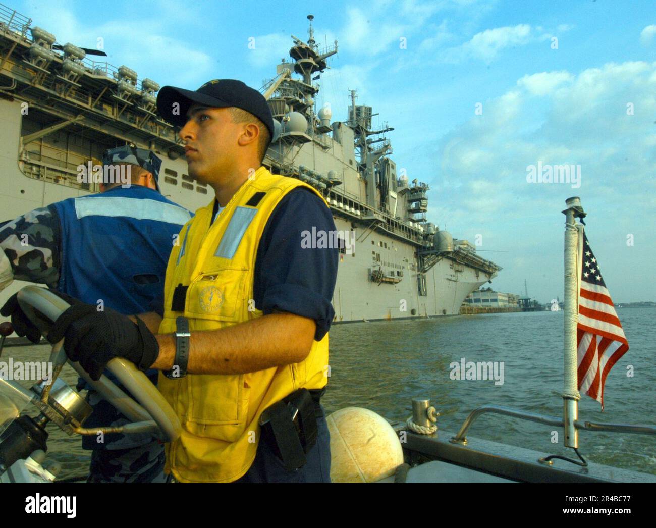 US Navy Seaman pilots a Rigid Hull Inflatable Boat (RHIB) boat past the ...