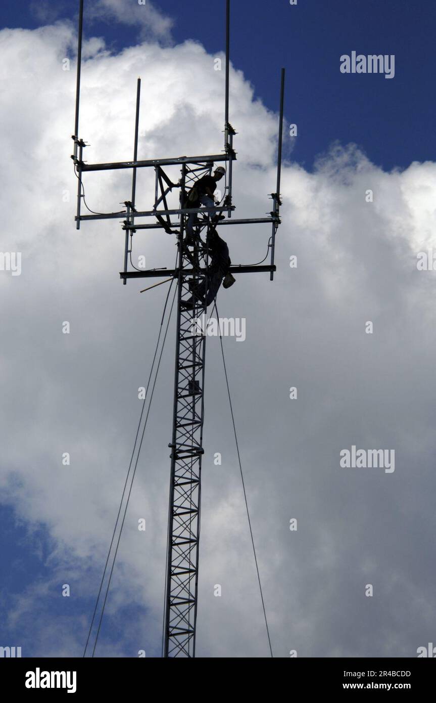 US Navy Cellular phone company personnel repair their reception towers ...