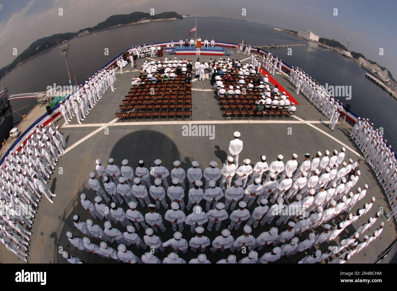 US Navy Sailors stand at parade rest on the flight deck of the U.S ...