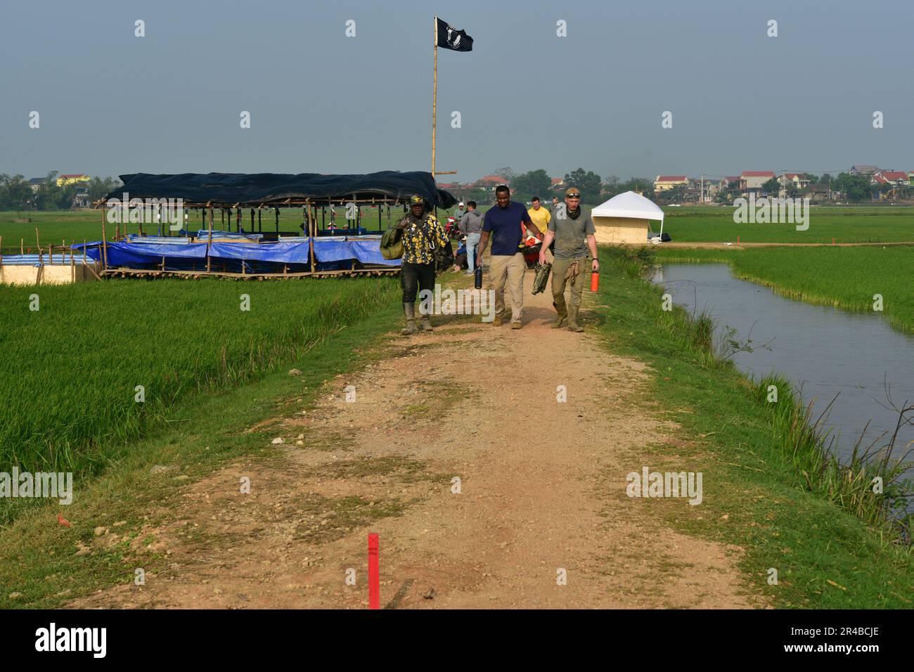 Members of the Defense POW/MIA Accounting Agency (DPAA) team, work at a ...