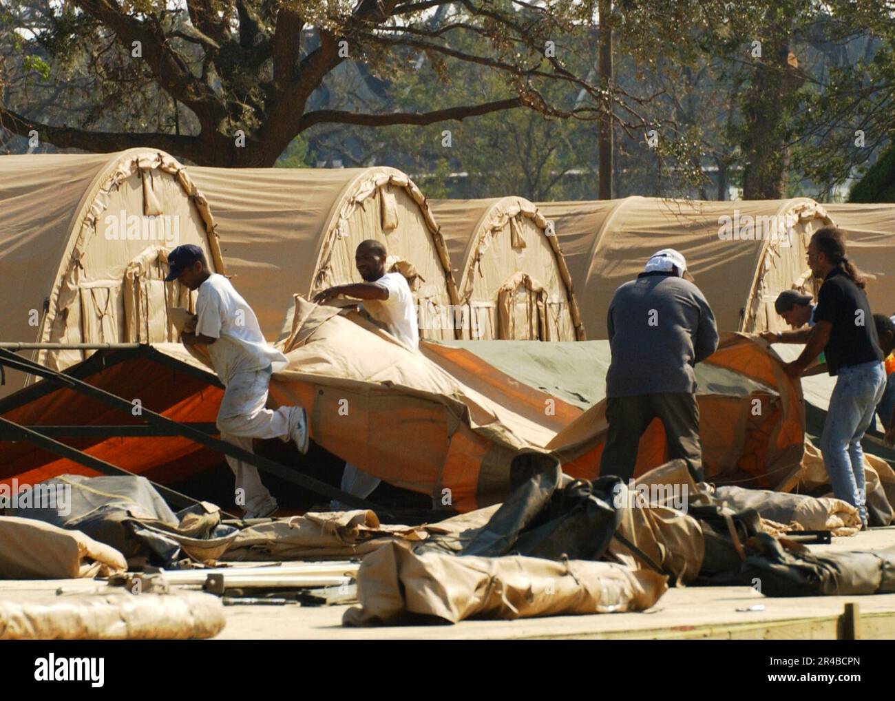US Navy Employees of Mountain Gear Sails Company construct large tents ...