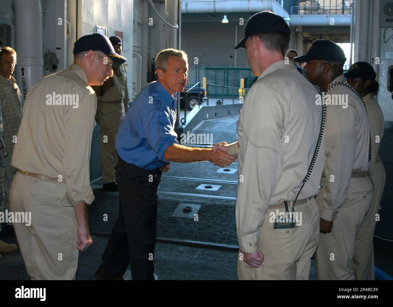 US Navy President George W. Bush pauses to shake the hand of the Navy ...