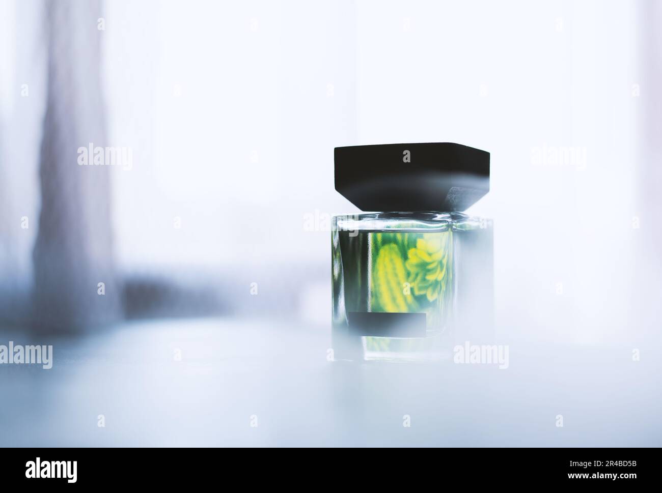 Bottle of men's perfume in smoke Stock Photo - Alamy