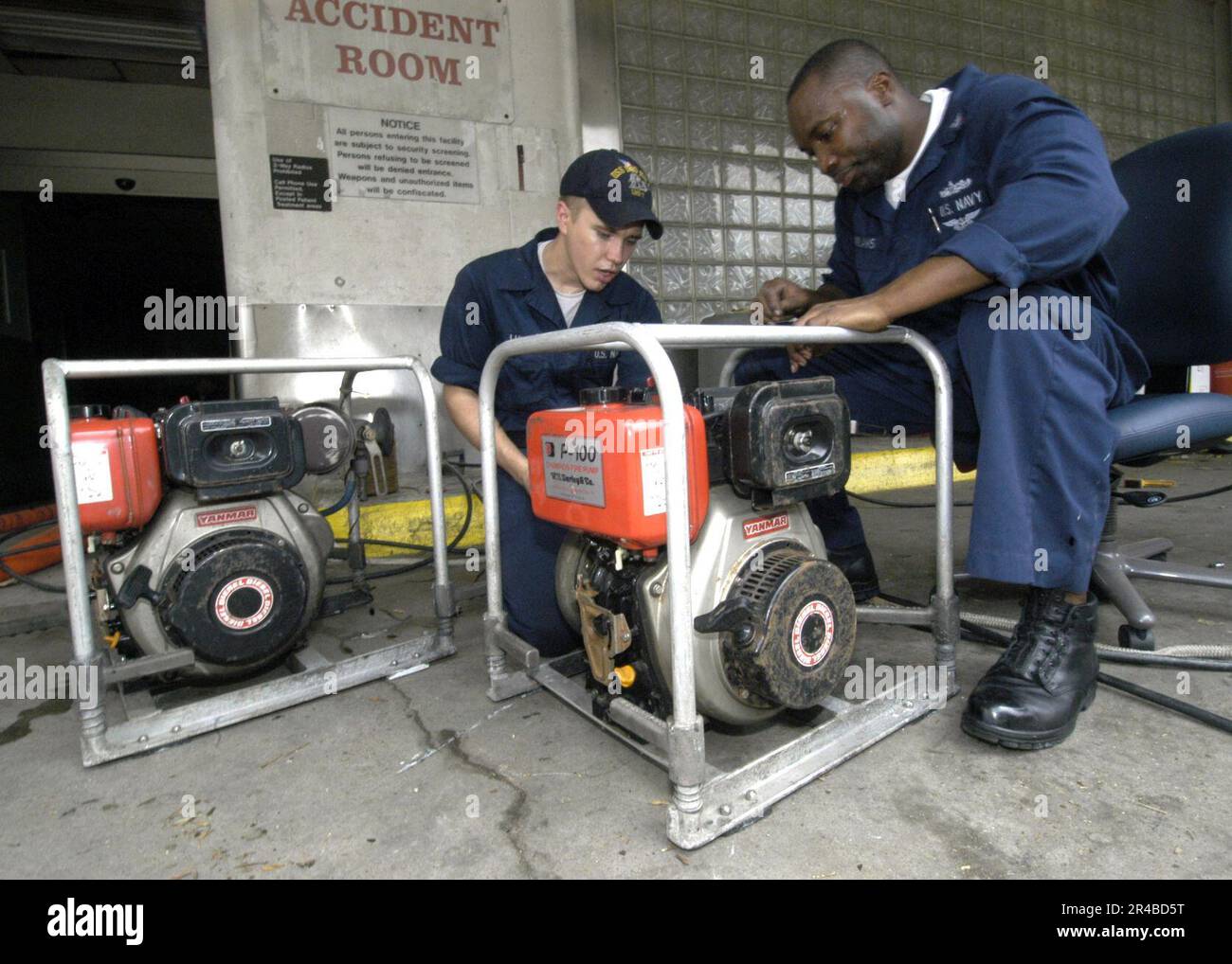 US Navy Damage Controlman 2nd Class and Hull Technician repair a P-100 ...