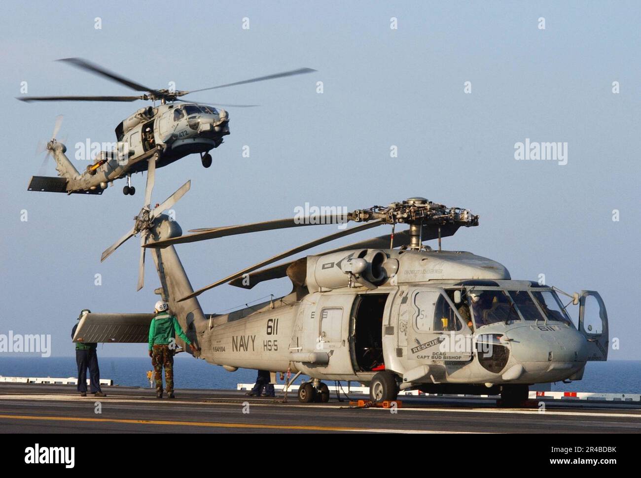 US Navy A SH-60B Seahawk helicopter prepares to land on the flight deck aboard the Nimitz-class ...